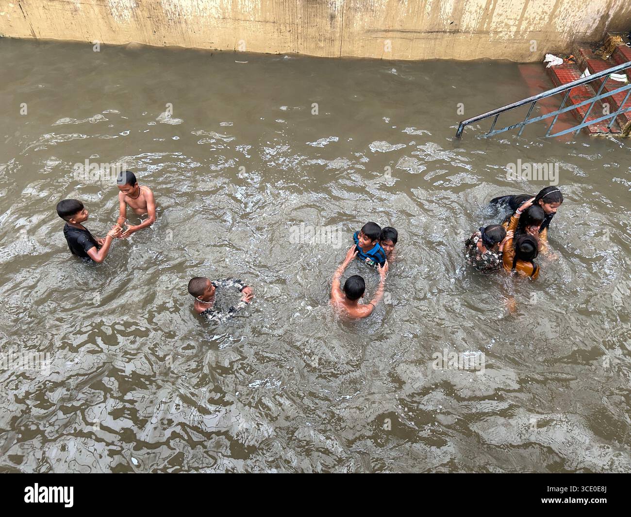 GURUGRAM, INDIA - AUGUST 14: Children takes bath in water logged Non ...