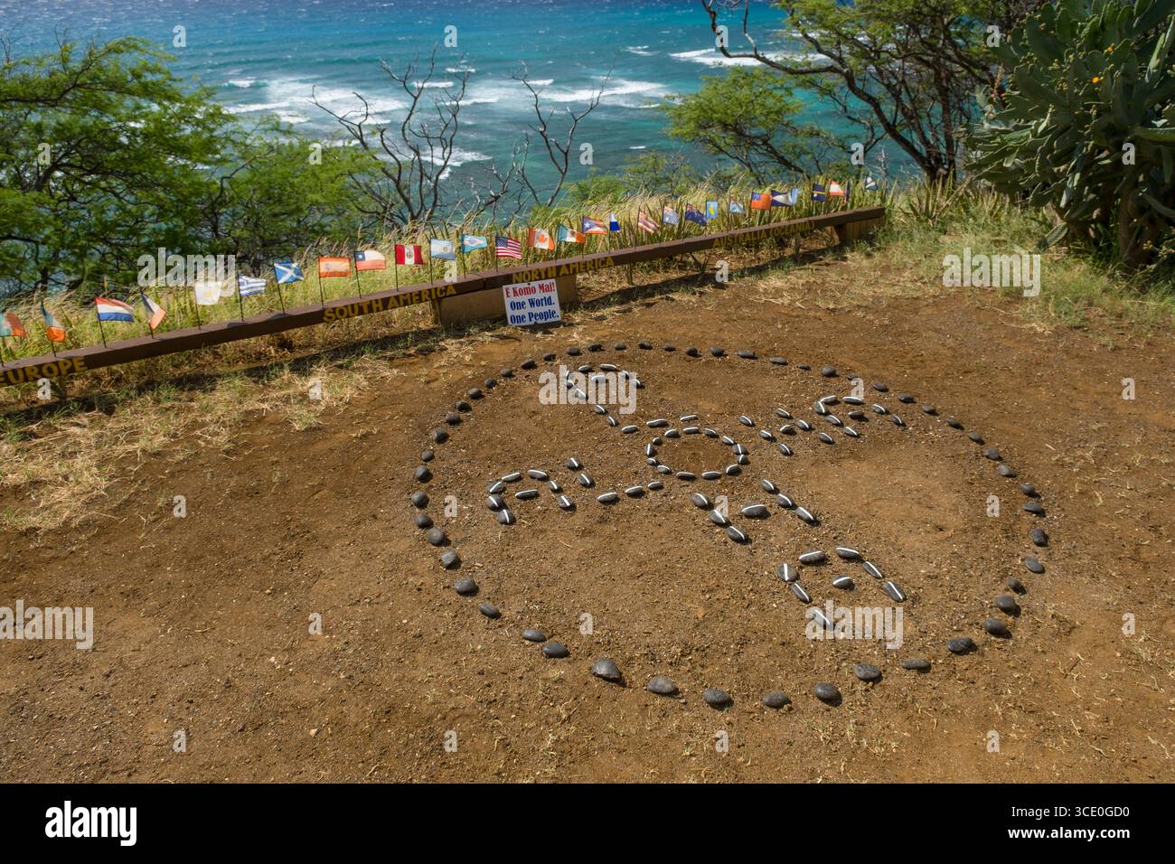 ALOHA written using small river stones with small flags of many nations ...