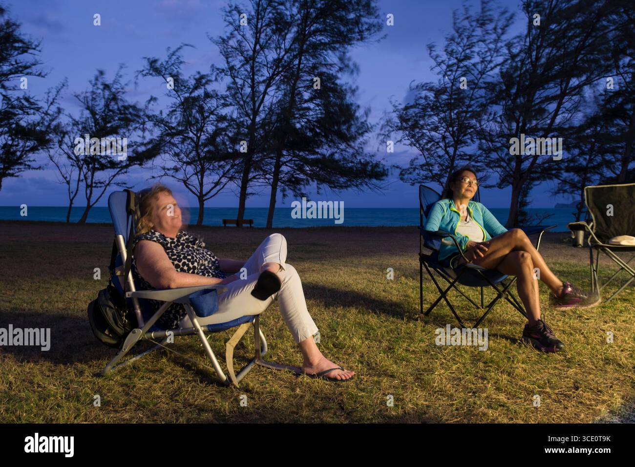 People sitting outside the rest and relaxation cabins at night, Bellows ...