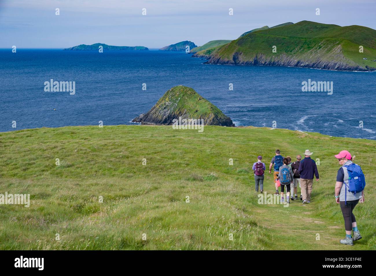Group of people hiking on Dunmore Head towards the westernmost point of ...