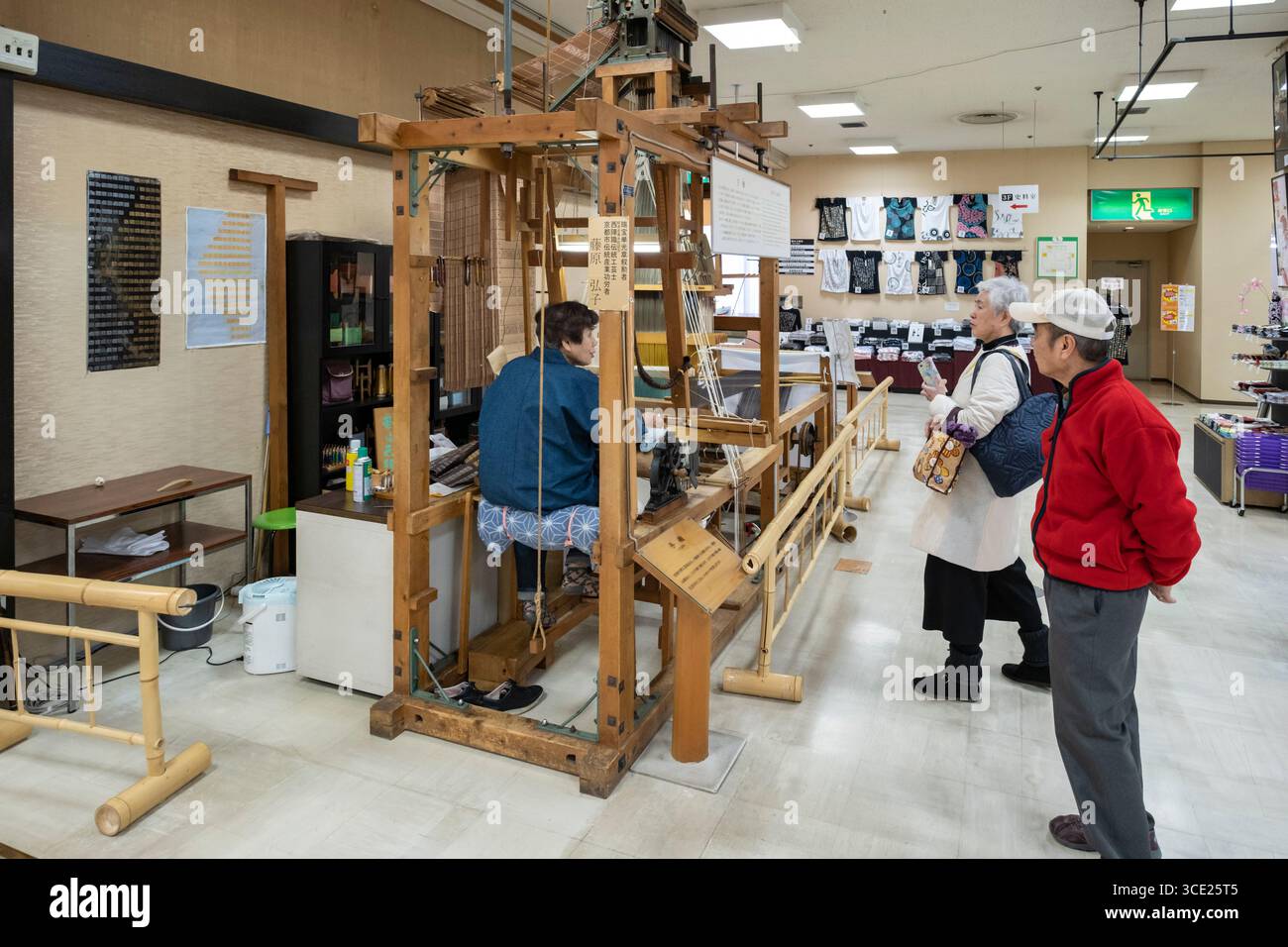 Woman demonstrating a hand loom with Jacquard attachment inside the ...