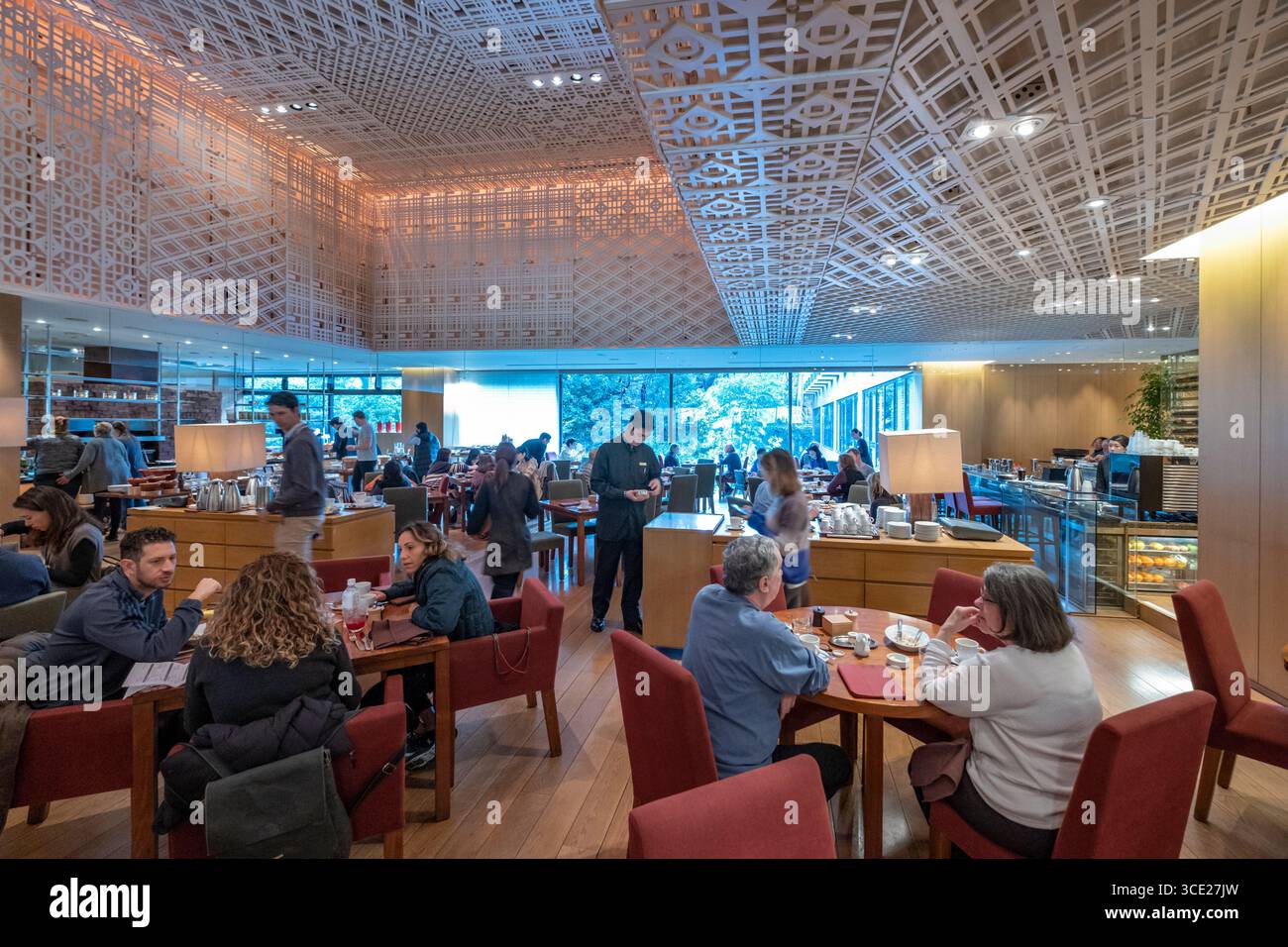 People sitting at tables eating breakfast in the Grill Restaurant ...