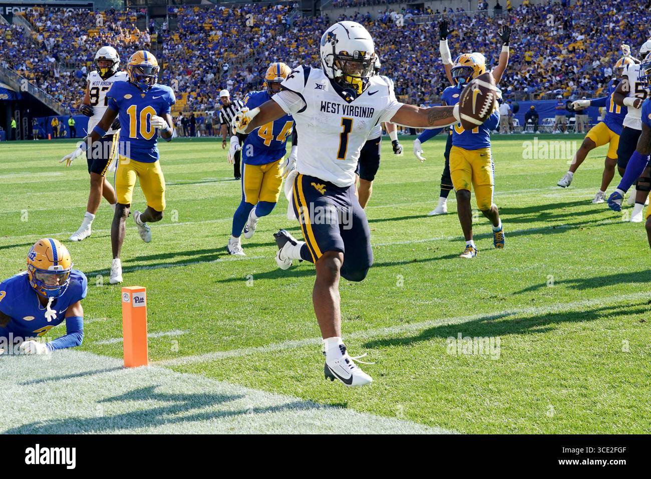 FILE - West Virginia running back Jahiem White (1) scores during the ...
