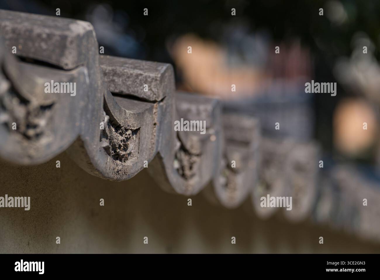 Detail of traditional Japanese ceramic tile on top of a masonry wall ...