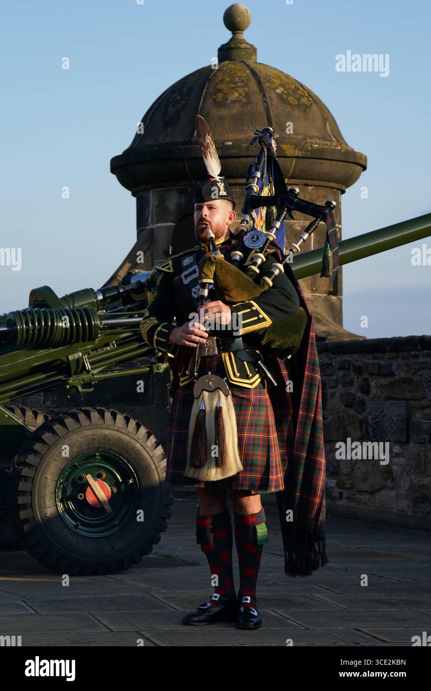 Warrant Officer Class 1, Senior Pipe Major Peter Grant plays at dawn at ...