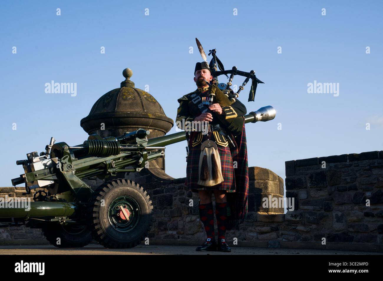 Warrant Officer Class 1, Senior Pipe Major Peter Grant plays at dawn at ...