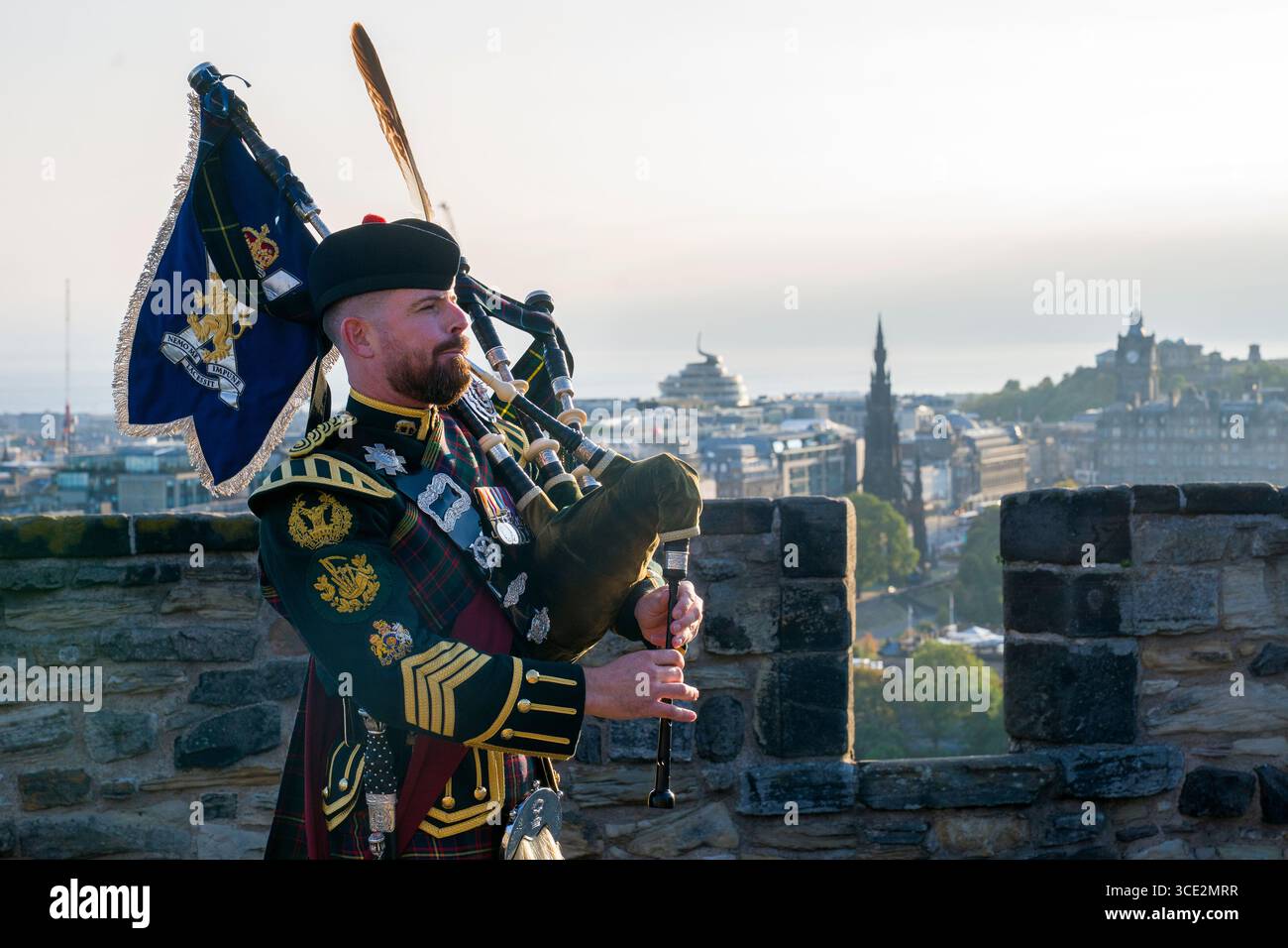 Warrant Officer Class 1, Senior Pipe Major Peter Grant plays at dawn at ...