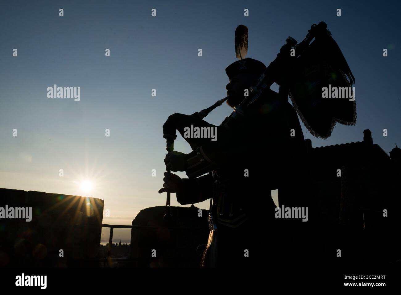 Warrant Officer Class 1, Senior Pipe Major Peter Grant plays at dawn at ...