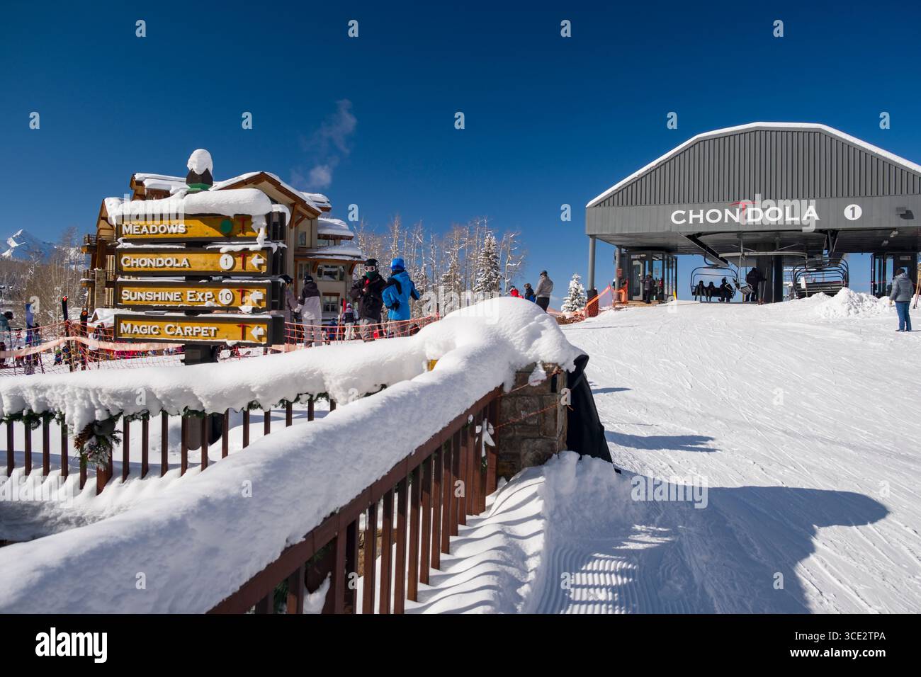 Snow covered sign with directions at Sunshine Plaza with Chondola Lift ...