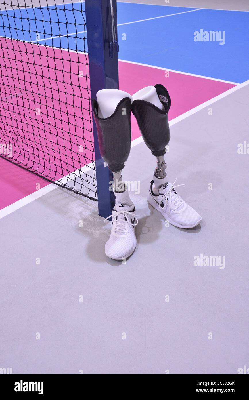 A pair of below-knee prosthetic legs, standing side-by-side on the edge ...