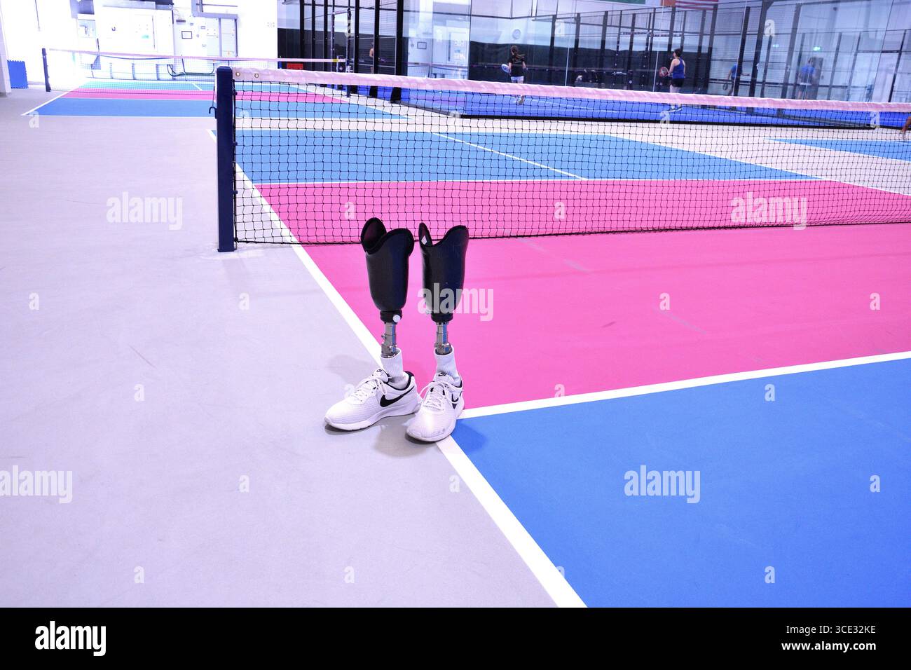 A pair of below-knee prosthetic legs, standing side-by-side on the edge ...