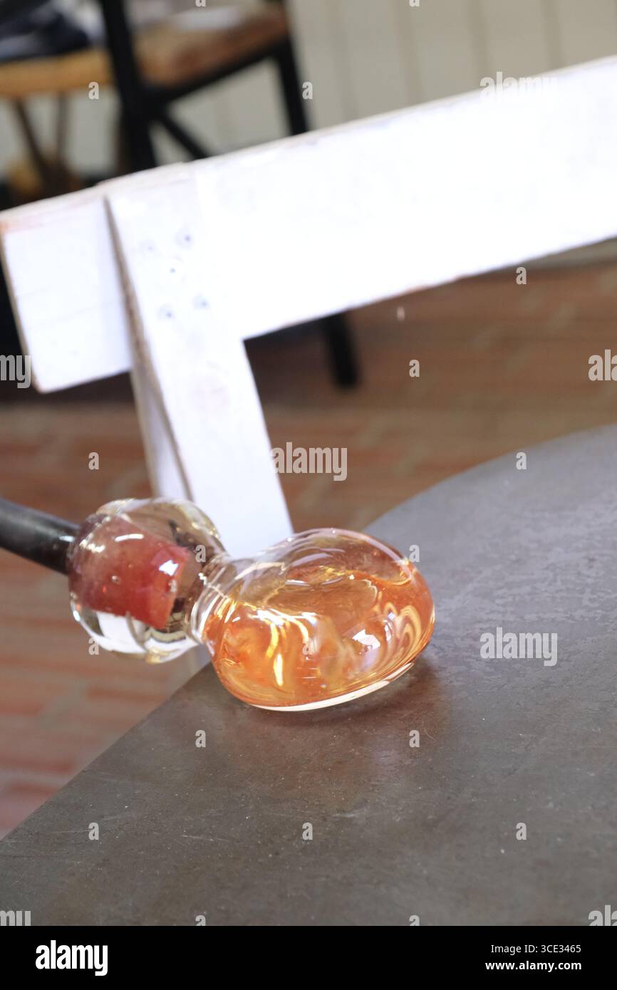 Melted glass on a pipe - early stage of the glass blowing process Stock ...