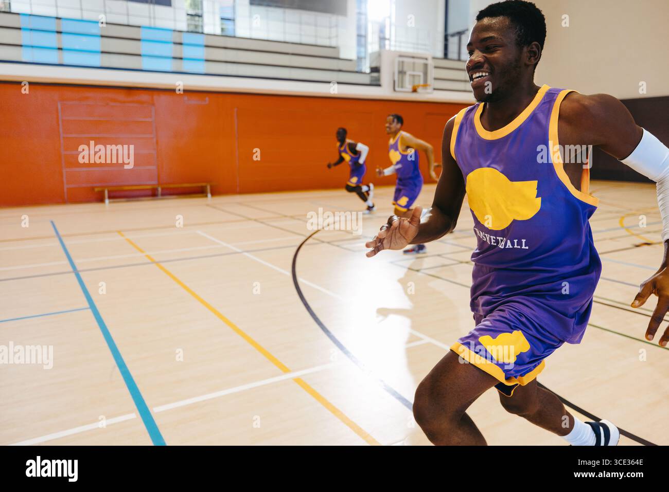 Basketball players in action, running on a court and showing teamwork ...