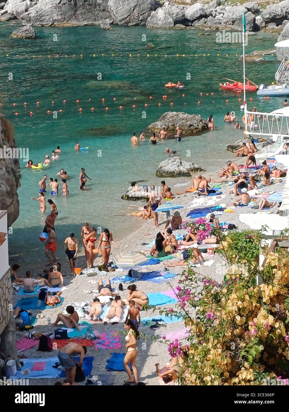 Summer: tourists and swimmers in a famous beach at isle of Capri (Italy ...