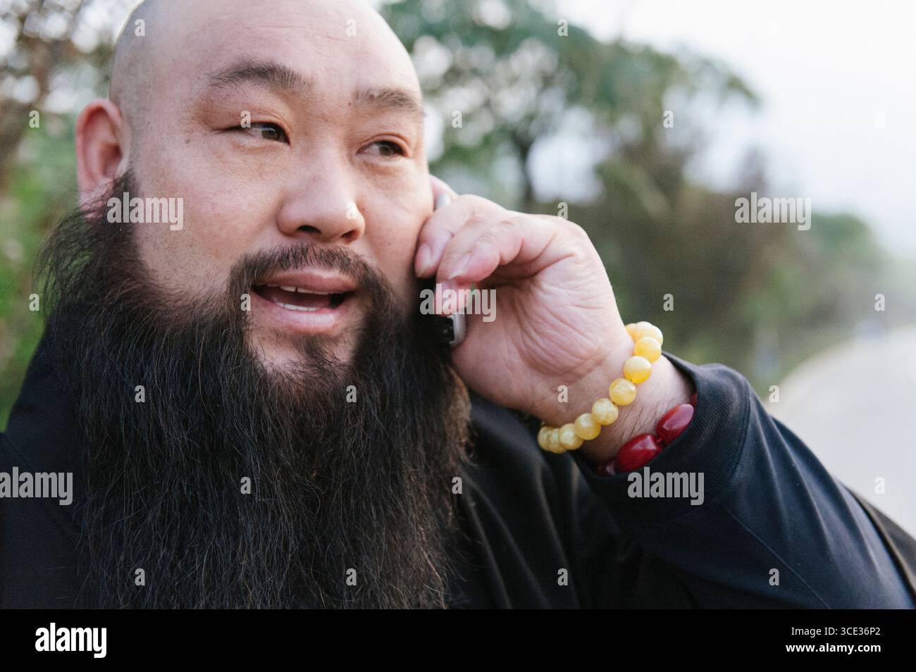 Shaolin Monk, Shi De Chao talking on his cell phone Stock Photo - Alamy
