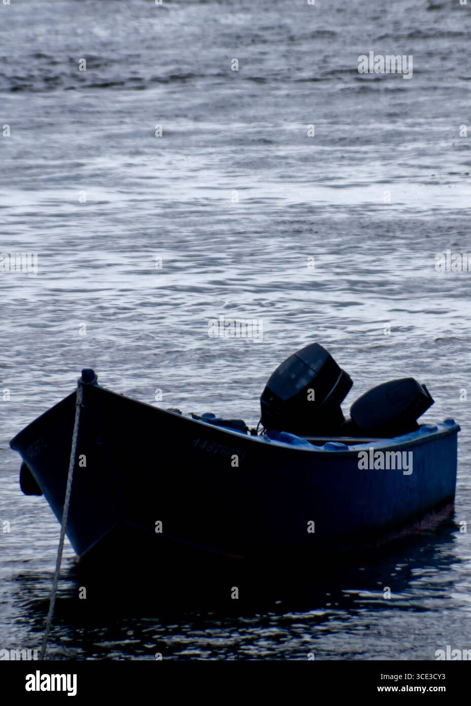 A small blue boat with a Yamaha engine floats on the water Stock Photo ...
