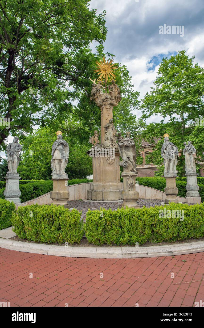 Ornate baroque Holy Trinity Column surrounded by saint statues in a ...