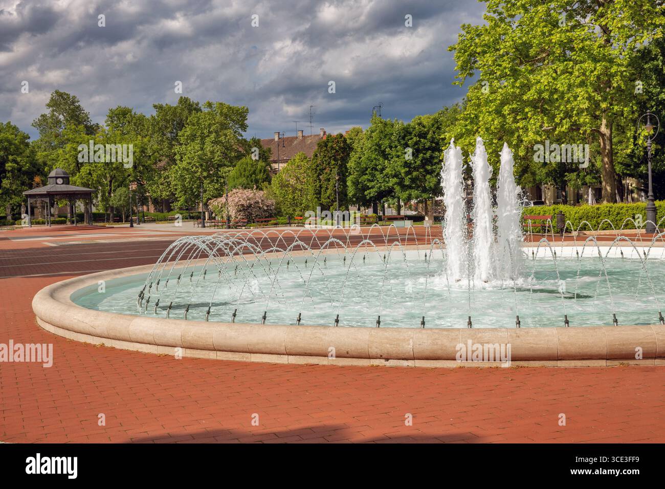 Ornate circular fountain with multiple water jets and spouts in a ...