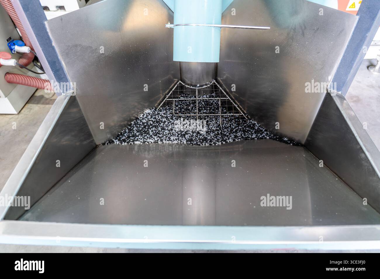 Plastic granules in industrial hopper for manufacturing, recycling ...