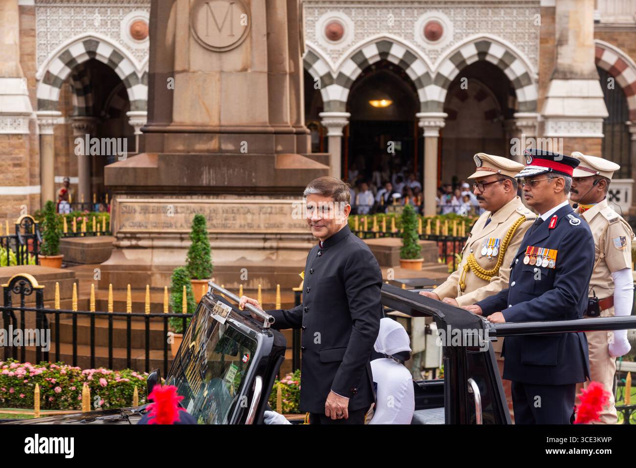 Municipal commissioner with security officials during a ceremonial parade at a historic monument ...