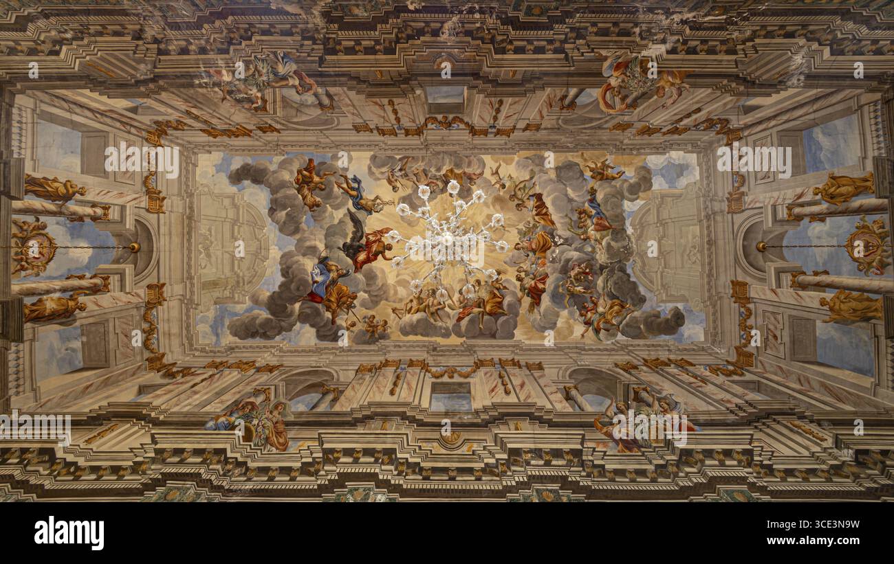 The elaborate baroque ceiling fresco with figures and floral motifs ...
