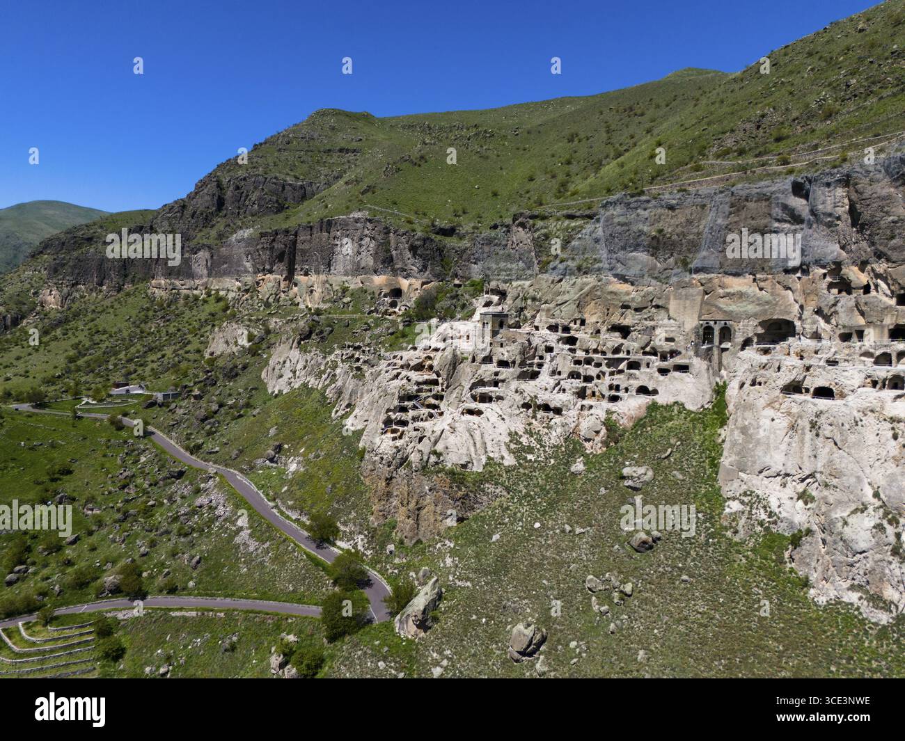 Cave architecture along an elongated rock formation, embedded in a ...