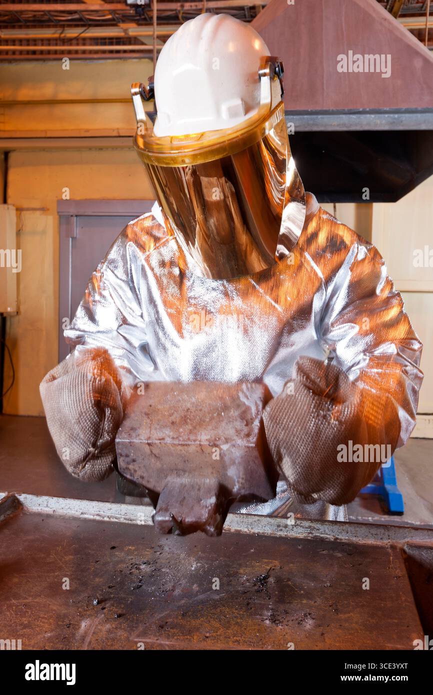 Filling casting form with melted gold in shielding gases Stock Photo ...