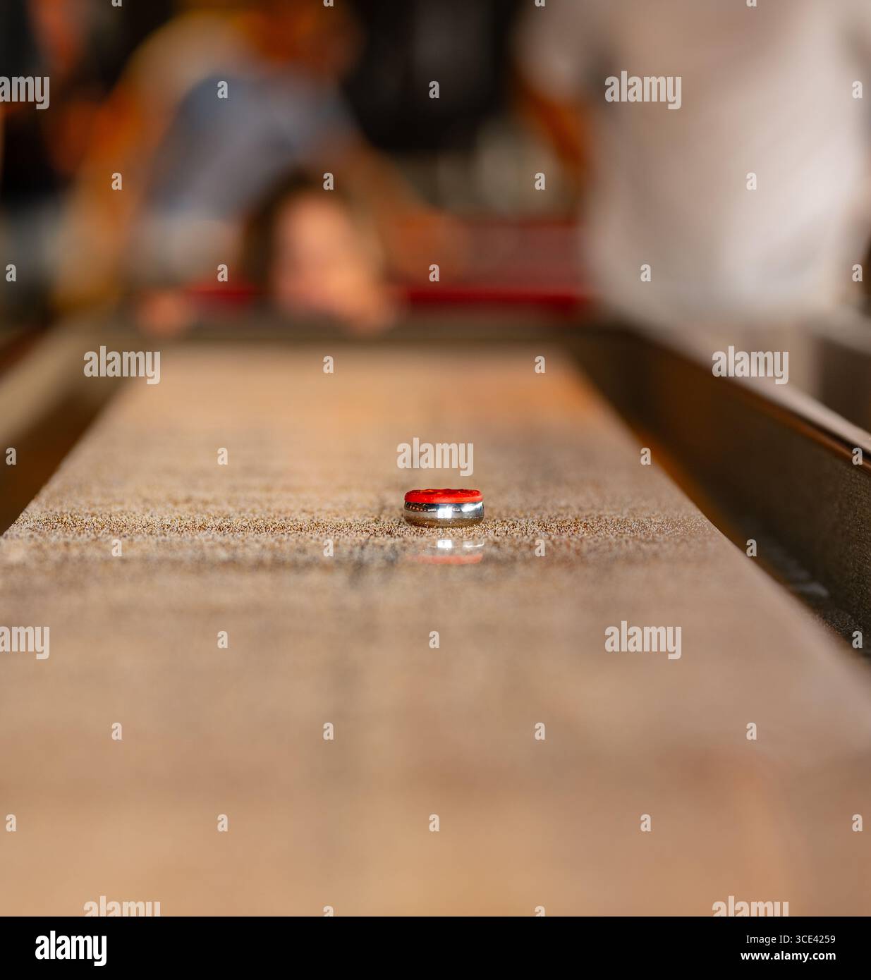 Playing a game of shuffleboard Stock Photo - Alamy