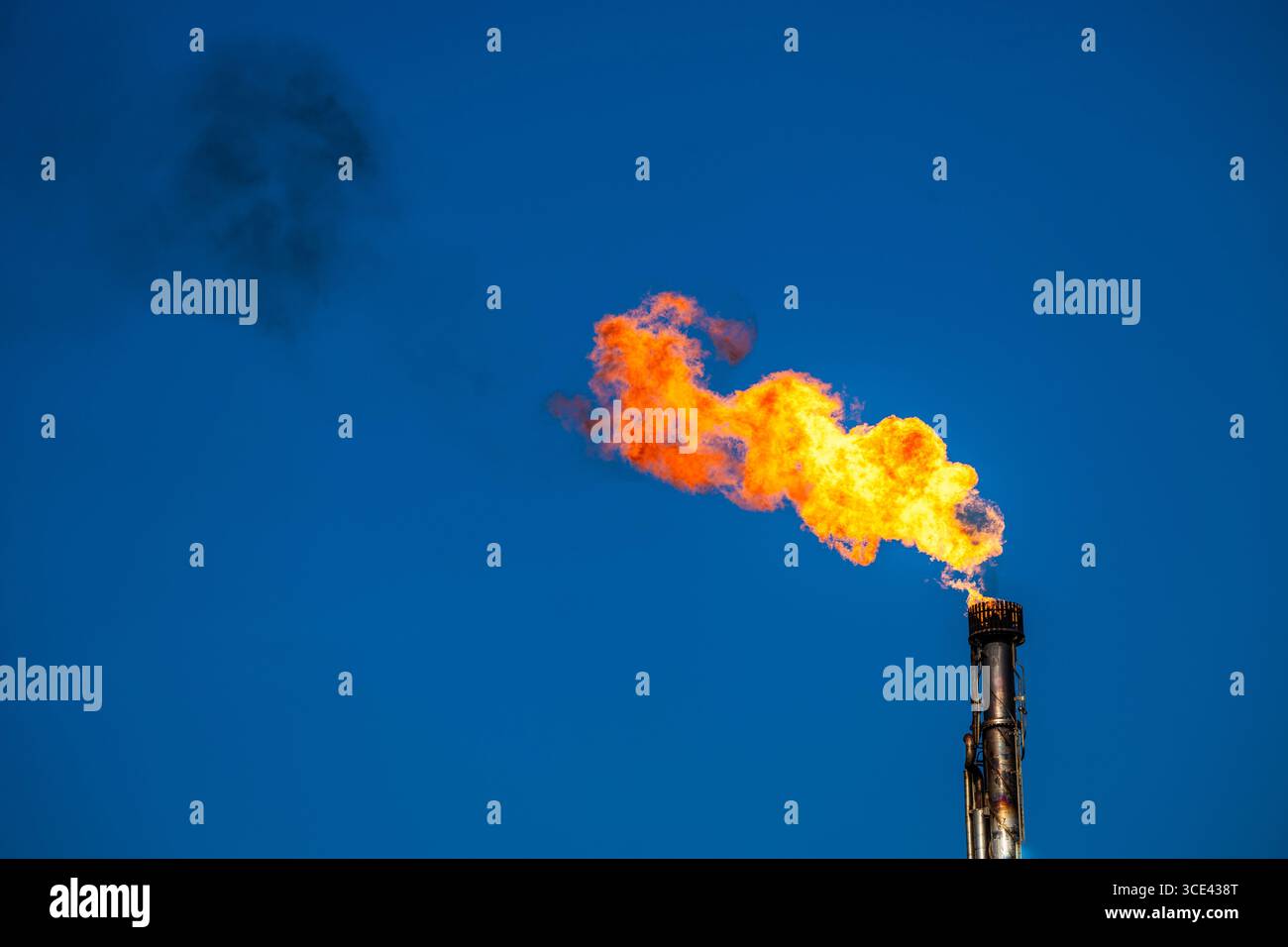 Flame burning off bi-product hydrocarbons at an oil refinery Stock ...