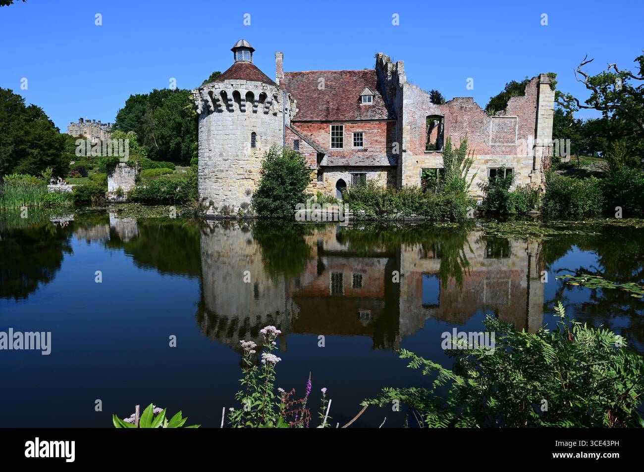 Ruins of a Medieval Moated Manor house by a lake in summertime Stock ...