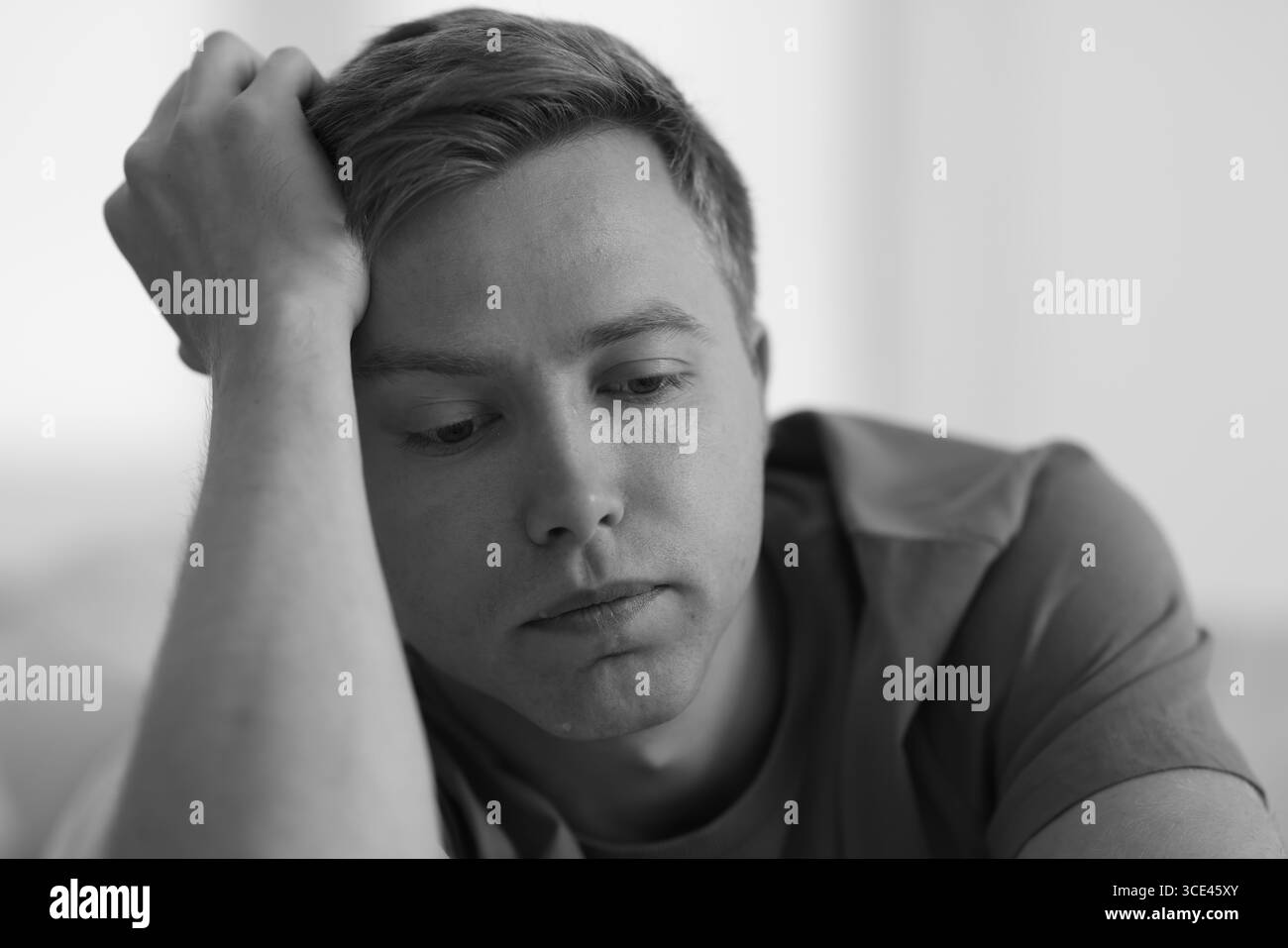 Sad man on blurred grey background, black and white effect Stock Photo ...
