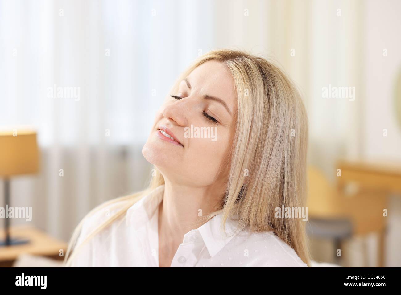 Dreams come true. Woman thinking about something at home Stock Photo ...