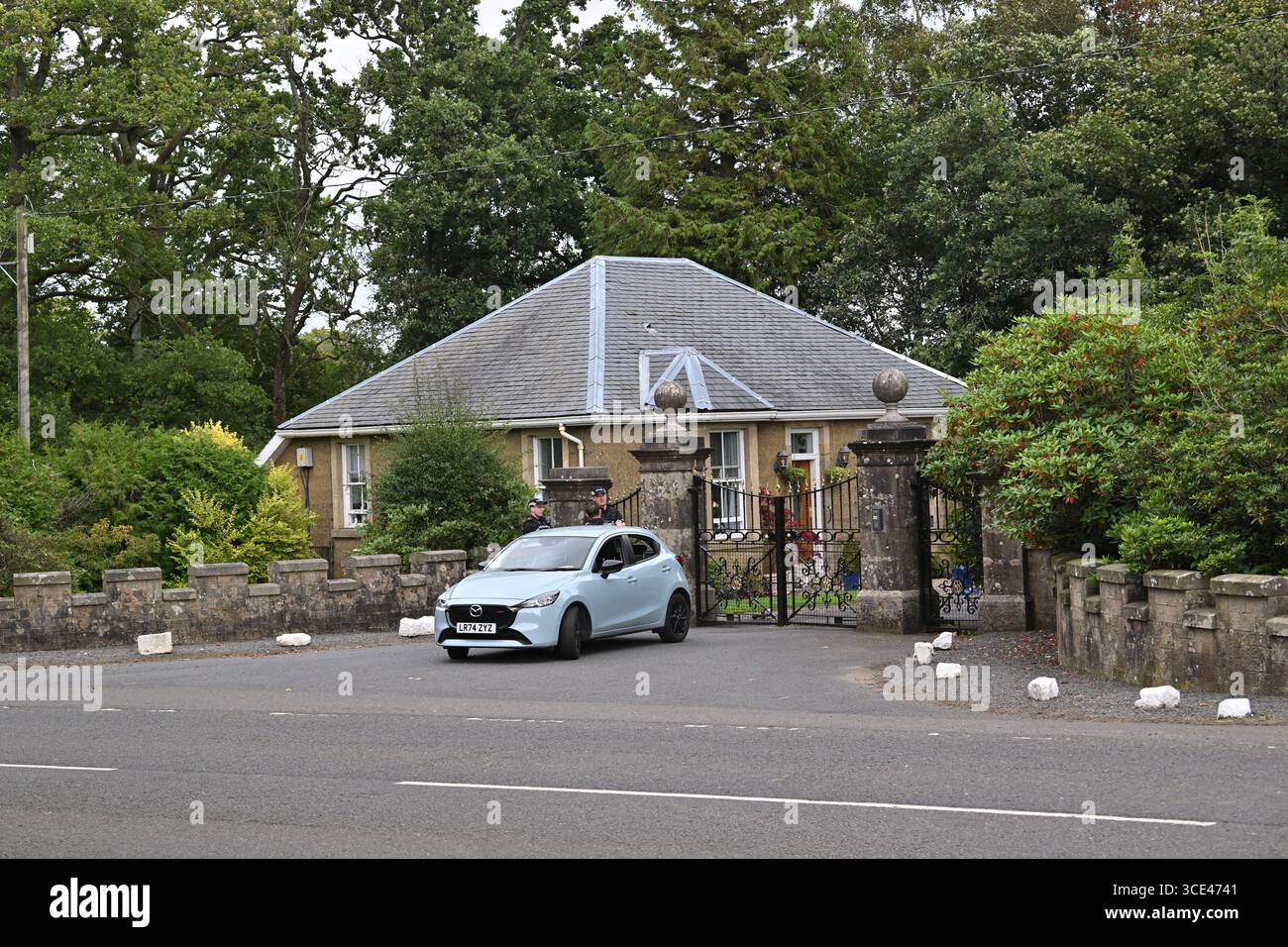 A security vehicle is parked in front of the entrance to the Carnell ...