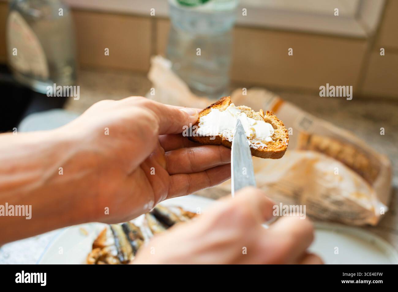 Spreading Cream Cheese on Toast Stock Photo - Alamy