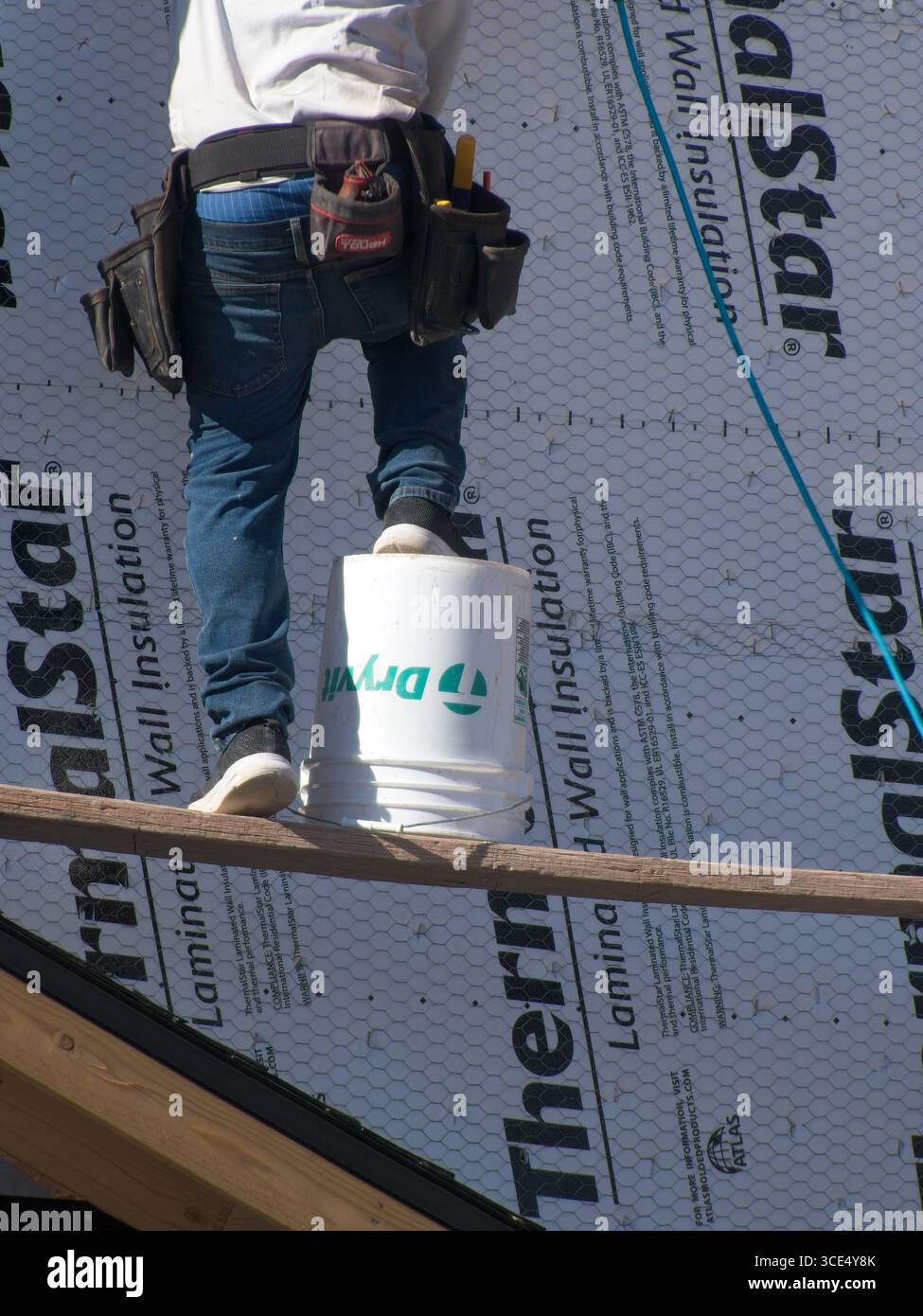 A construction worker uses unsafe work practices as he works high off the ground. Montrose ...
