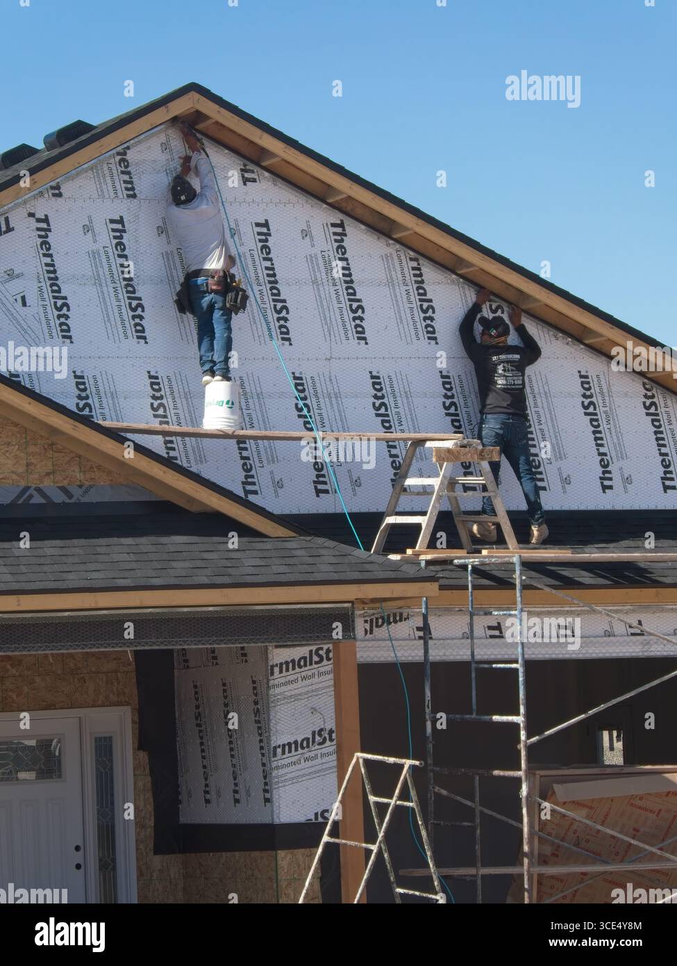 A construction worker uses unsafe work practices as he works high off the ground. Montrose ...