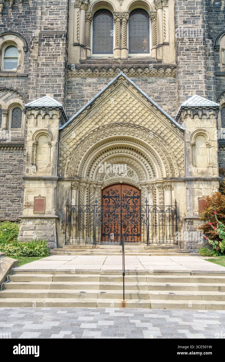 Ornate arched entrance with decorative stonework and wooden doors at ...