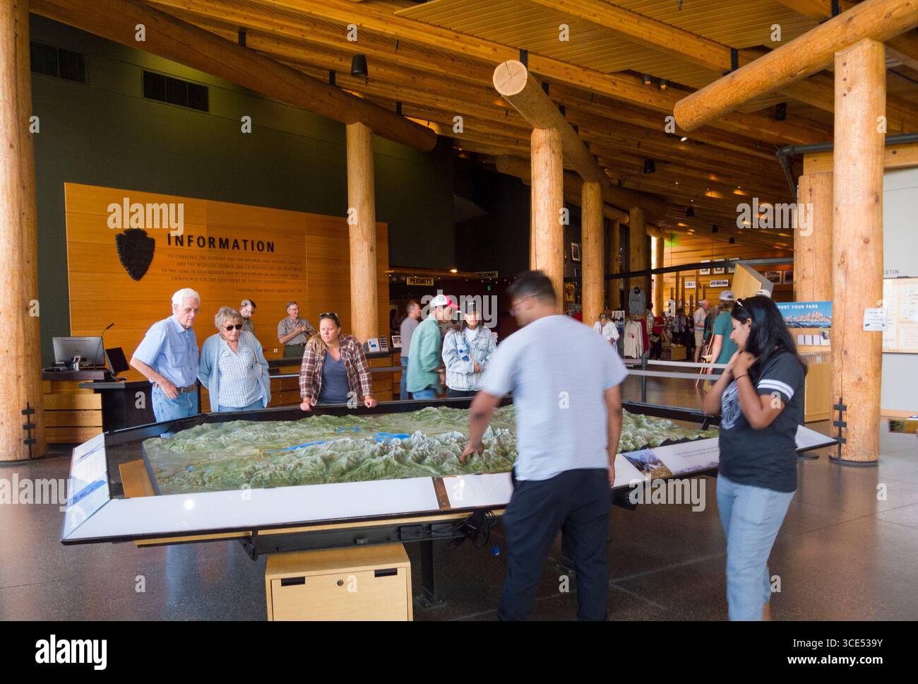 Visitors looking at raised-relief map inside the Craig Thomas Discovery ...