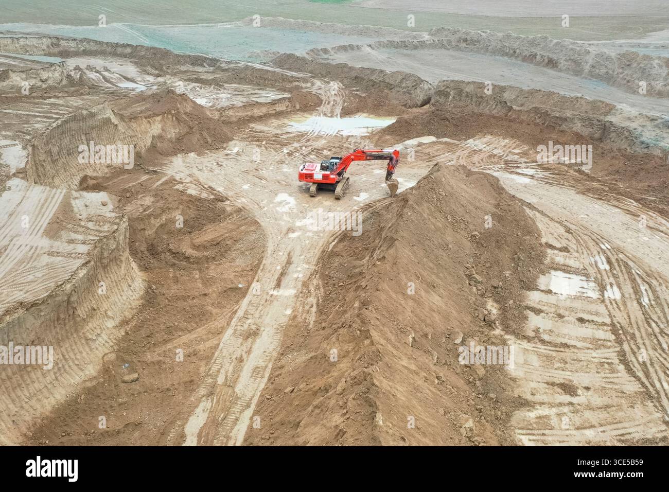 Quarry for the extraction of earthy soil, excavator in the quarry Stock ...