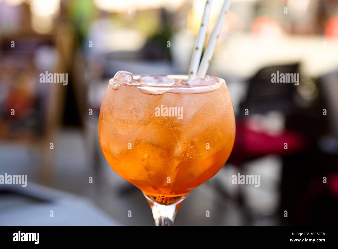 Aperol spritz cocktail in a glass with ice cubes and orange slice ...