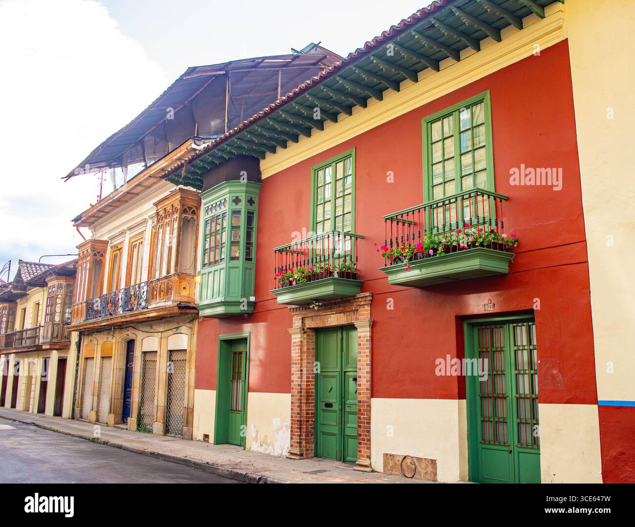 Vibrant colonial buildings with green balconies and red walls in Bogotá ...