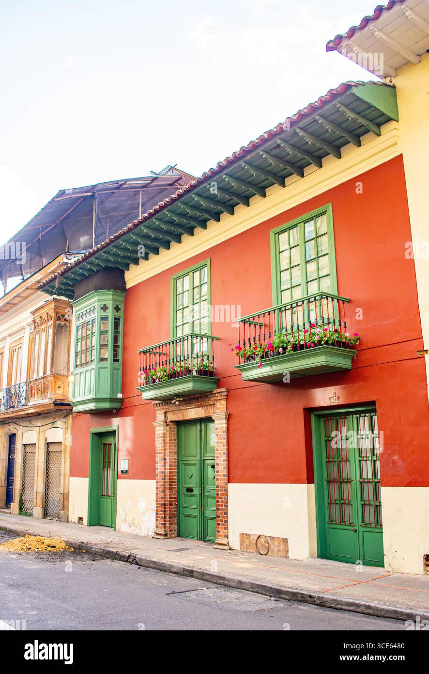 Vibrant colonial buildings with green windows and red walls in Bogotá ...