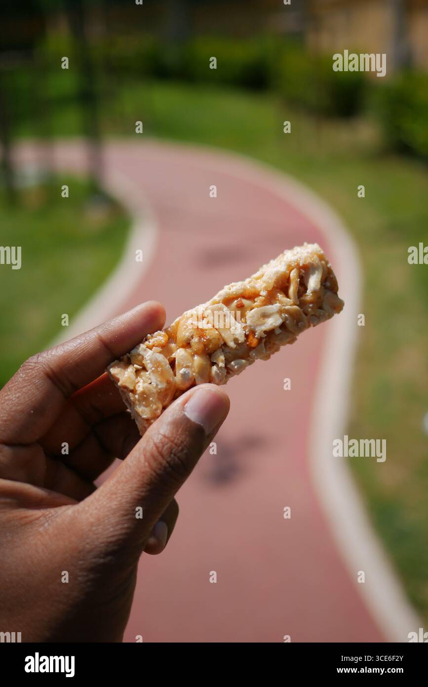 Delicious hand-held snack on a garden path Stock Photo - Alamy