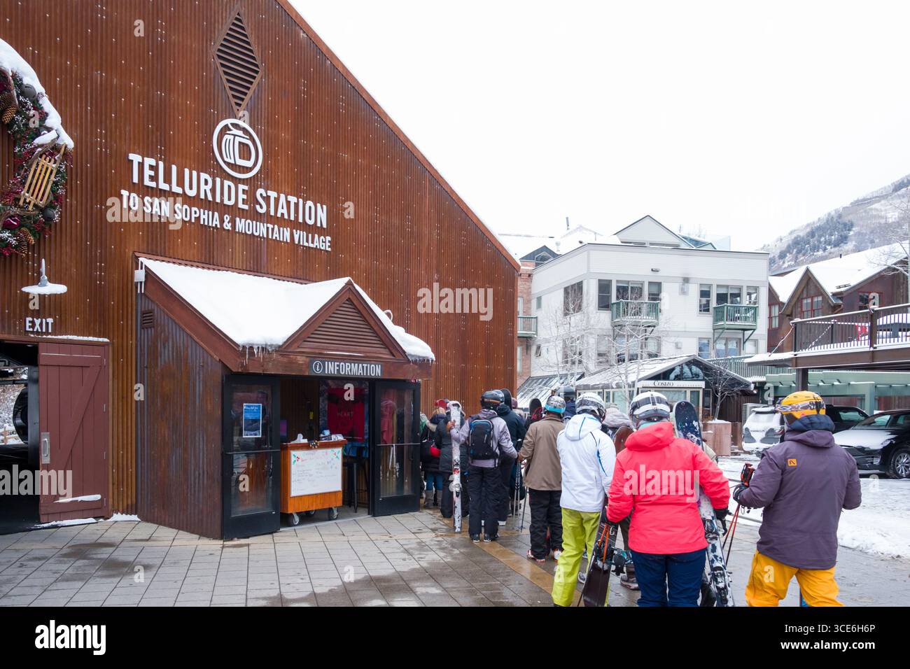 Skiers standing in line at the entrance to the Telluride station of the ...