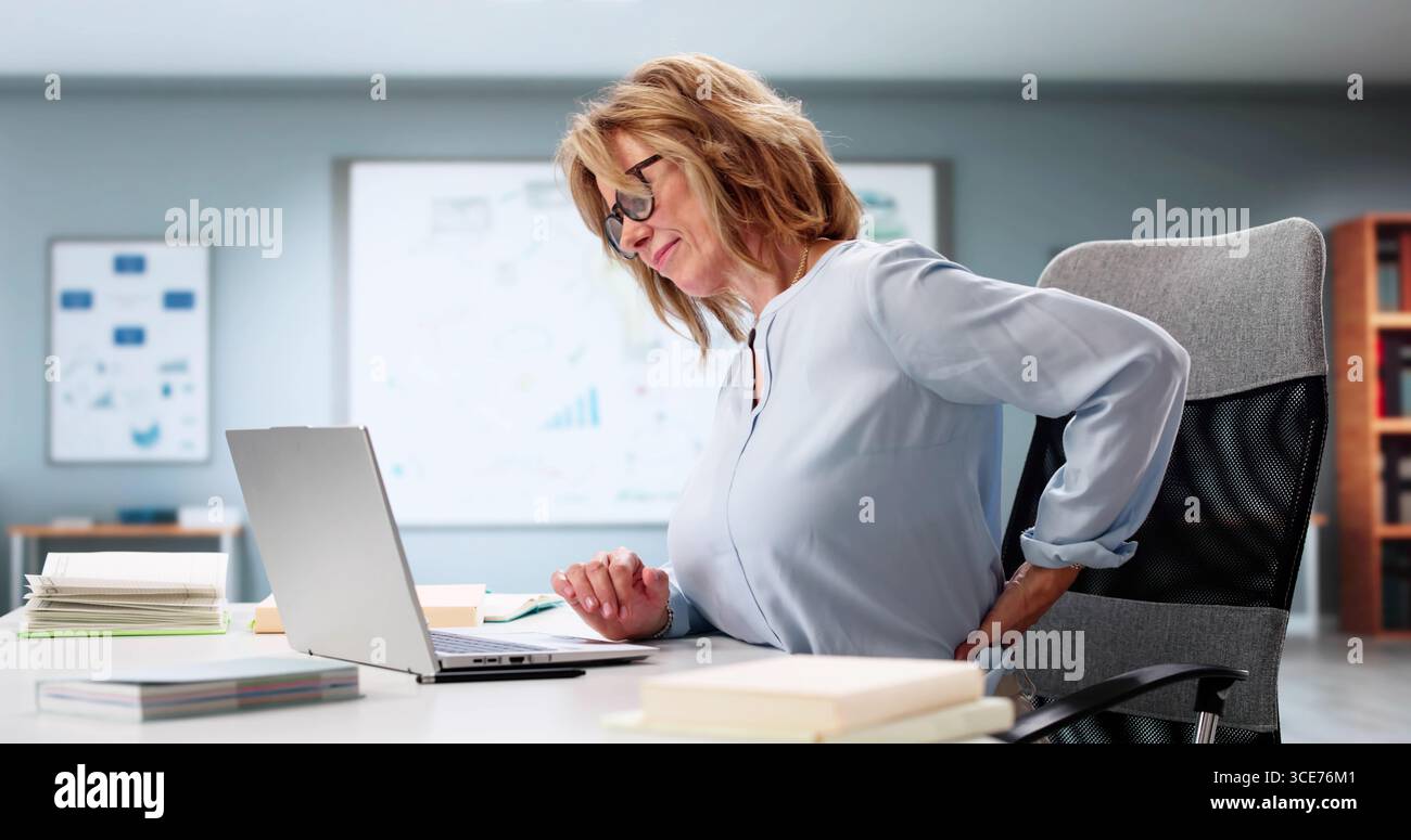 Woman In Office Struggles With Lower Back Pain From Poor Posture Stock ...