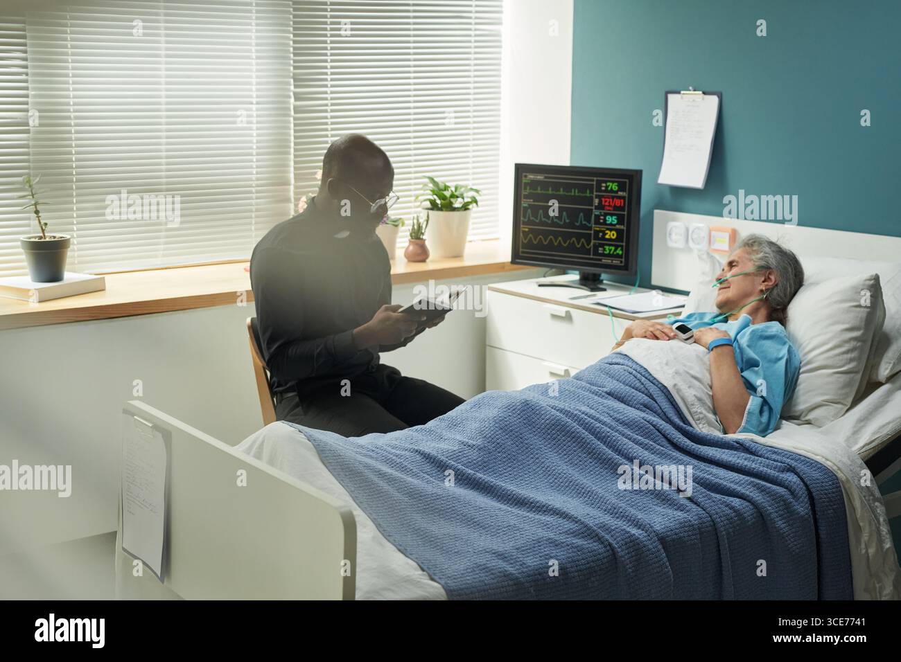 Black Male Priest Reading Bible to Senior Caucasian Woman in Hospital ...