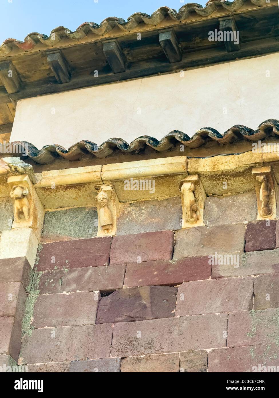 Detail of carved stone corbels with human figures on the apse of San ...