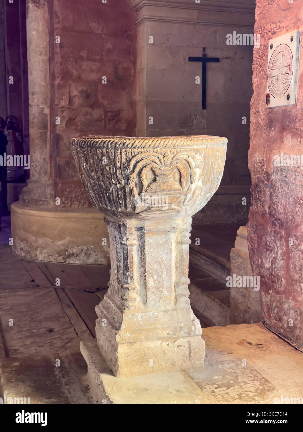 Medieval stone baptismal font with carved decorations in rural Spanish ...