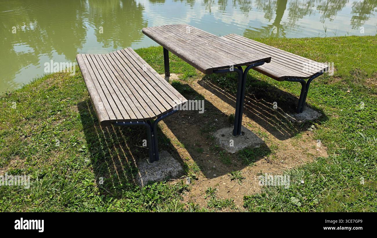 Simple park dining area features natural wood benches and tabletop ...