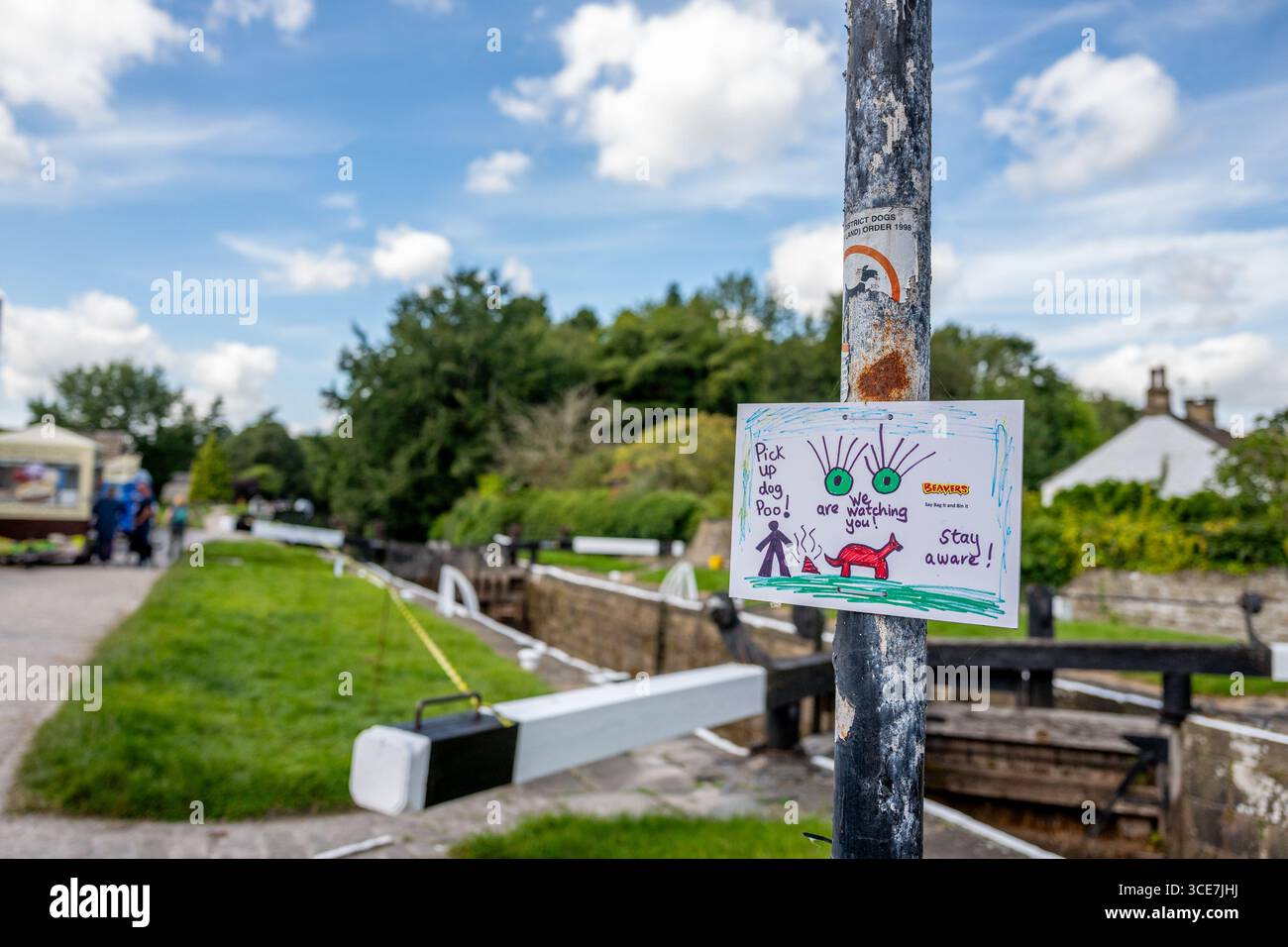 Childs drawing informing to pick up dog poo attached to the directional ...